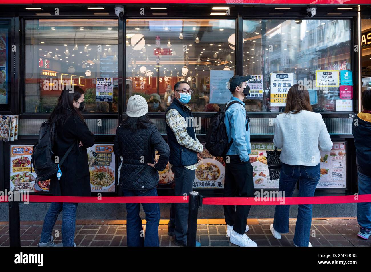 Hong Kong, China. 07th Jan, 2023. People queue in line to enter a ...