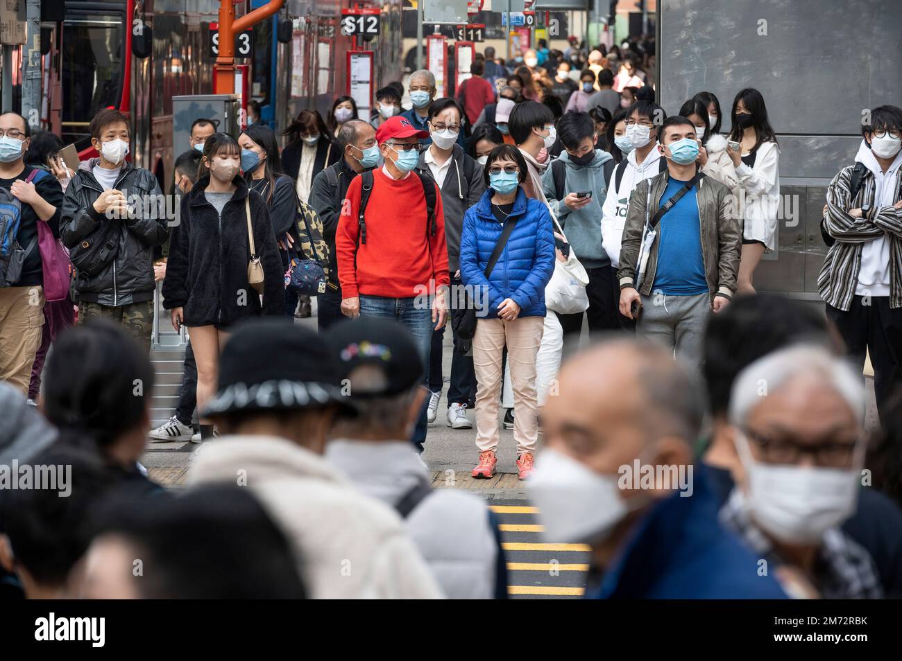 Hong Kong, China. 07th Jan, 2023. Pedestrians wait on the sidewalk for ...