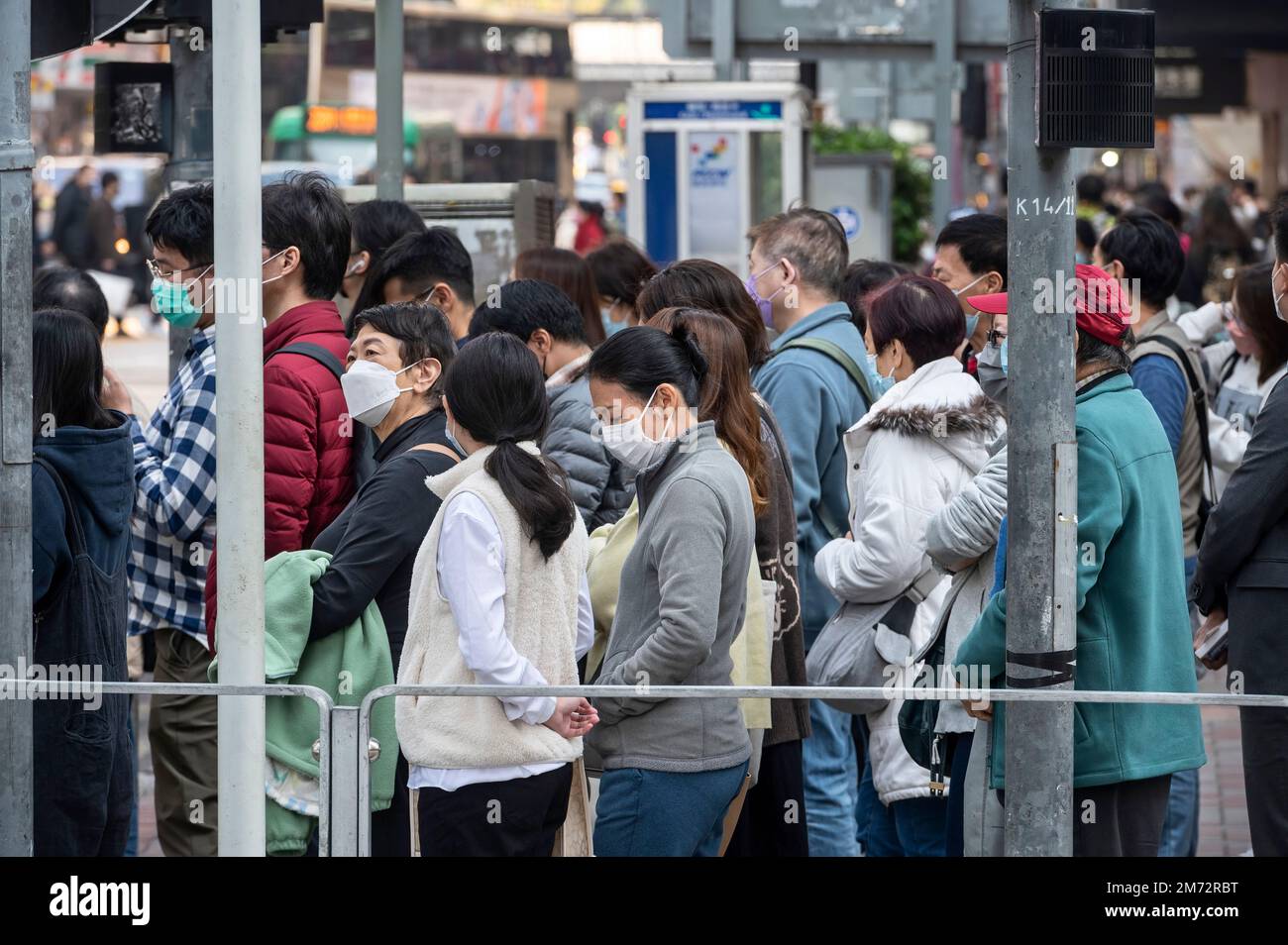 Hong Kong, China. 07th Jan, 2023. Pedestrians wait on the sidewalk for ...
