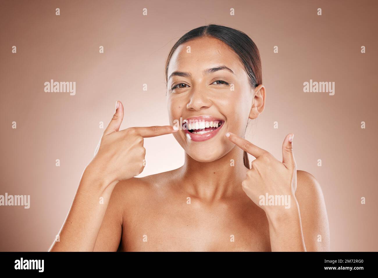 Dental, portrait and woman pointing to teeth on studio background for ...
