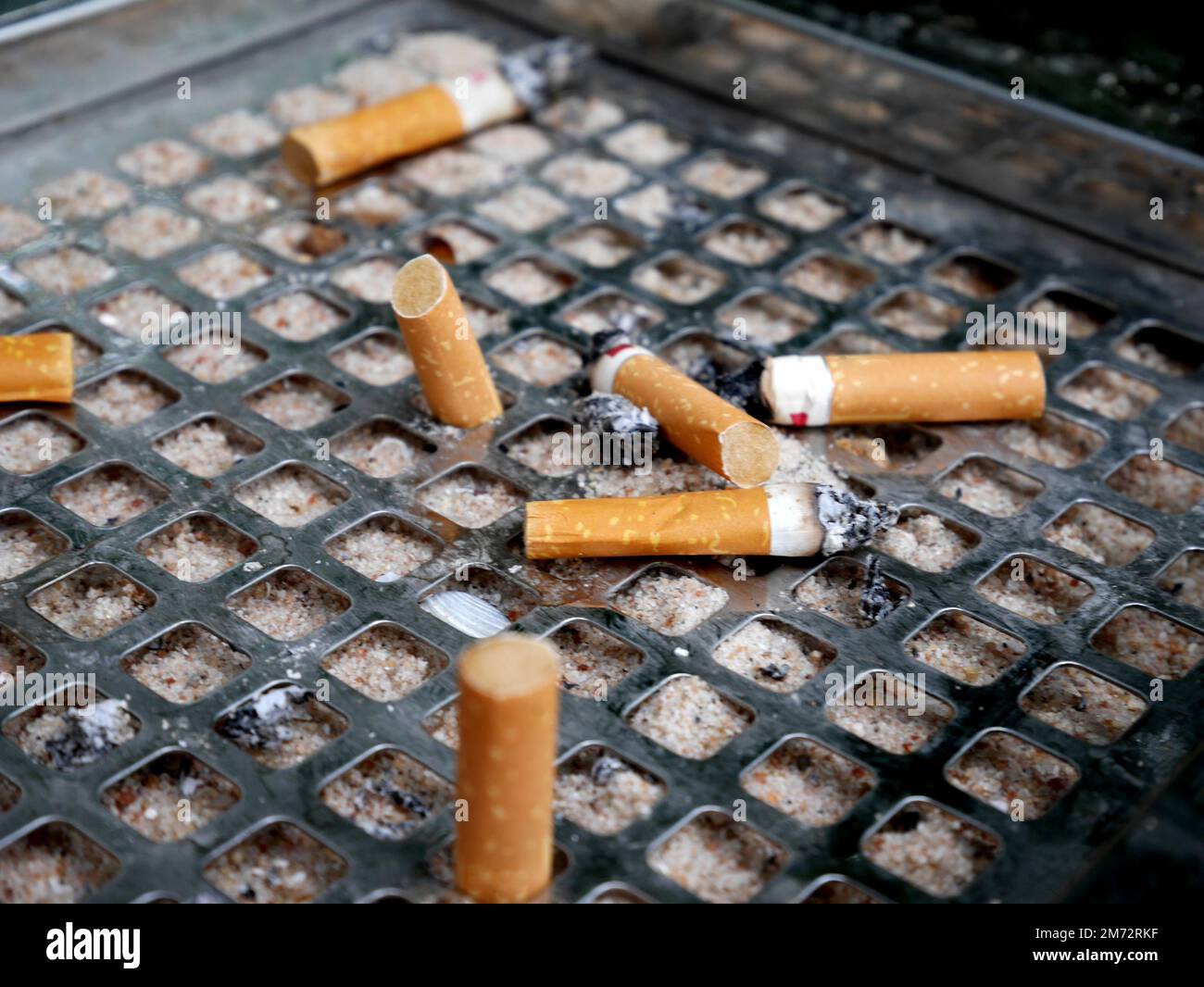 Selective focus cigarettes left in ashtray at smoking area Stock Photo ...