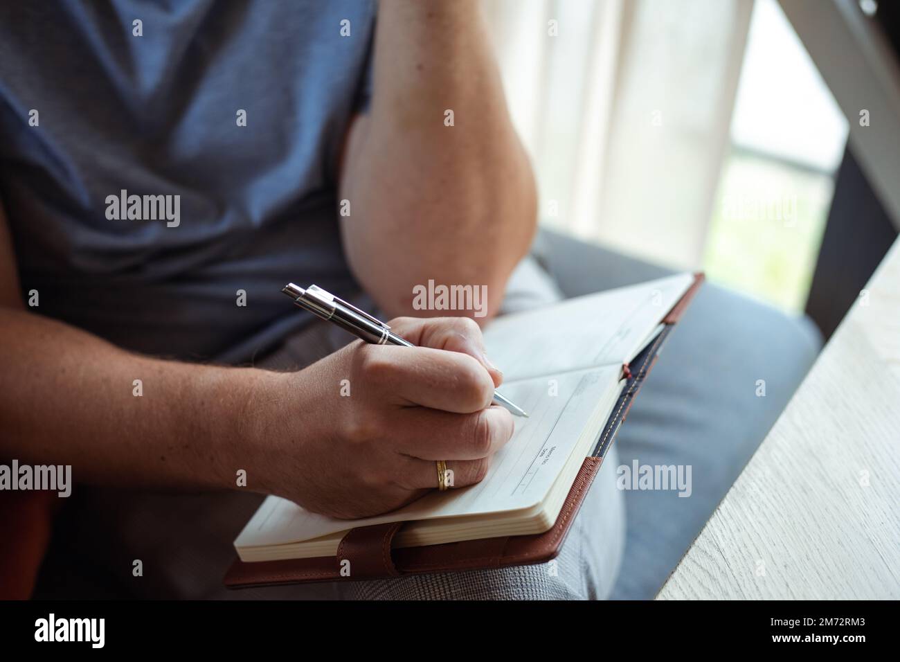 Unrecognizable, cropped man hands writing, making notes with pen in ...