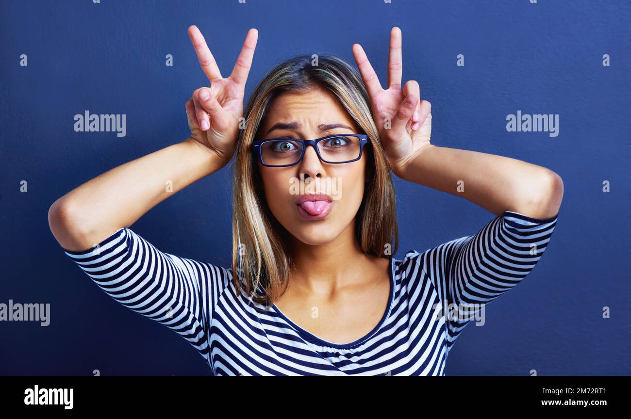 Monkey business. Portrait of a beautiful young woman making a silly ...