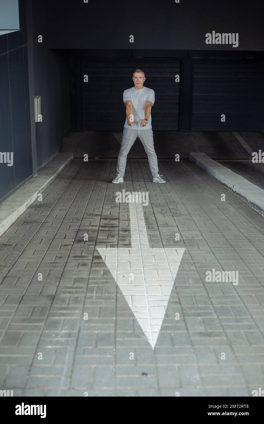 Vertical full length shot of confident gray haired man in gray outfit ...