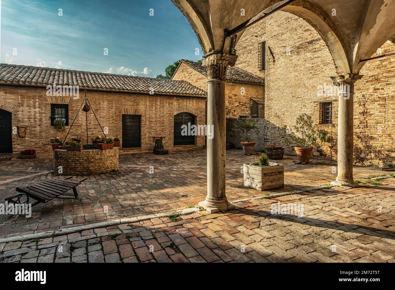 Medieval courtyard in the city of Recanati. Portico with arched vaults ...