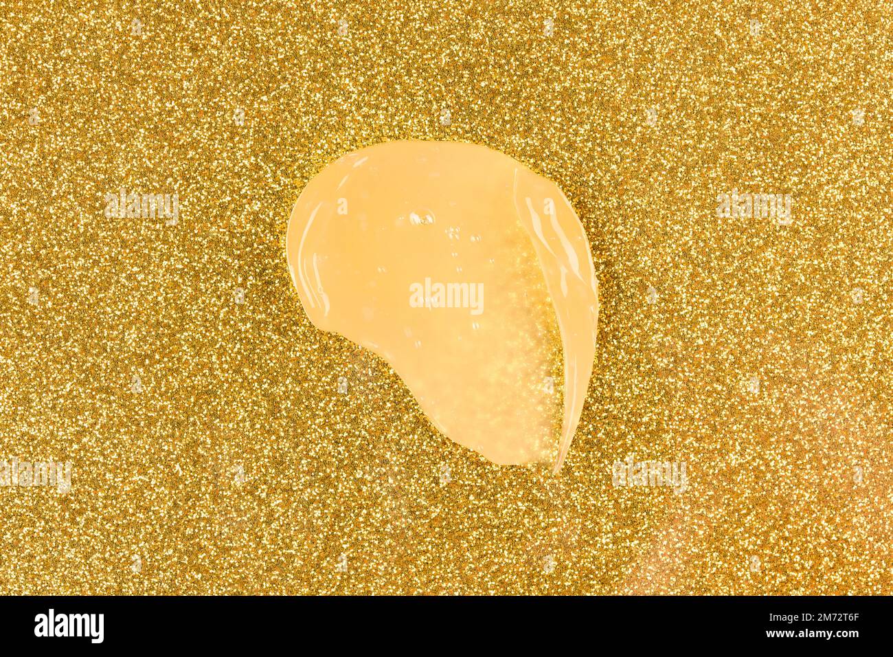 Golden cream smudge. Skincare product with bio-gold, face or eye cream ...