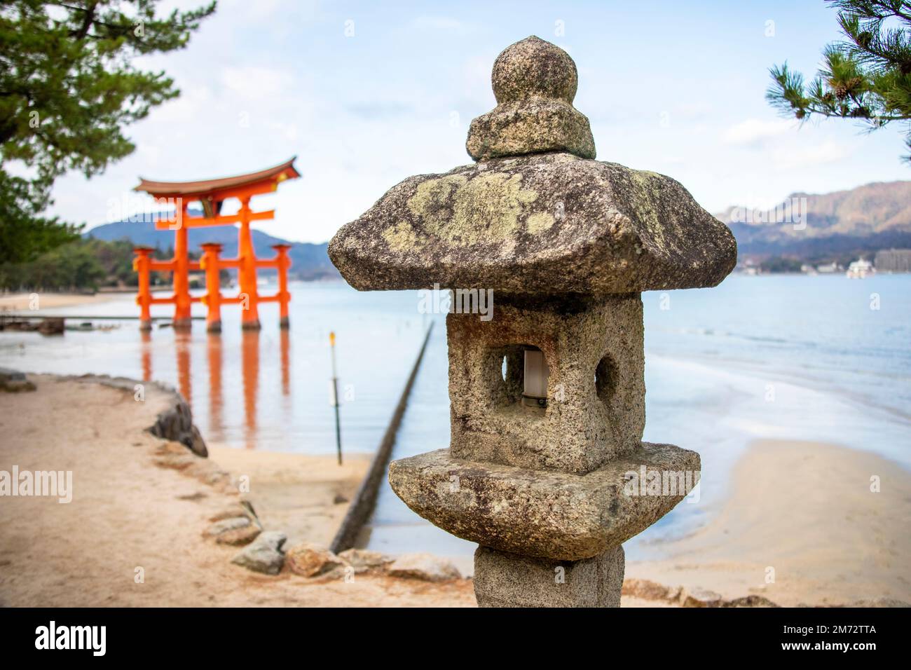 The stone lantern in the island of Miyajima Japan. Background is the ...