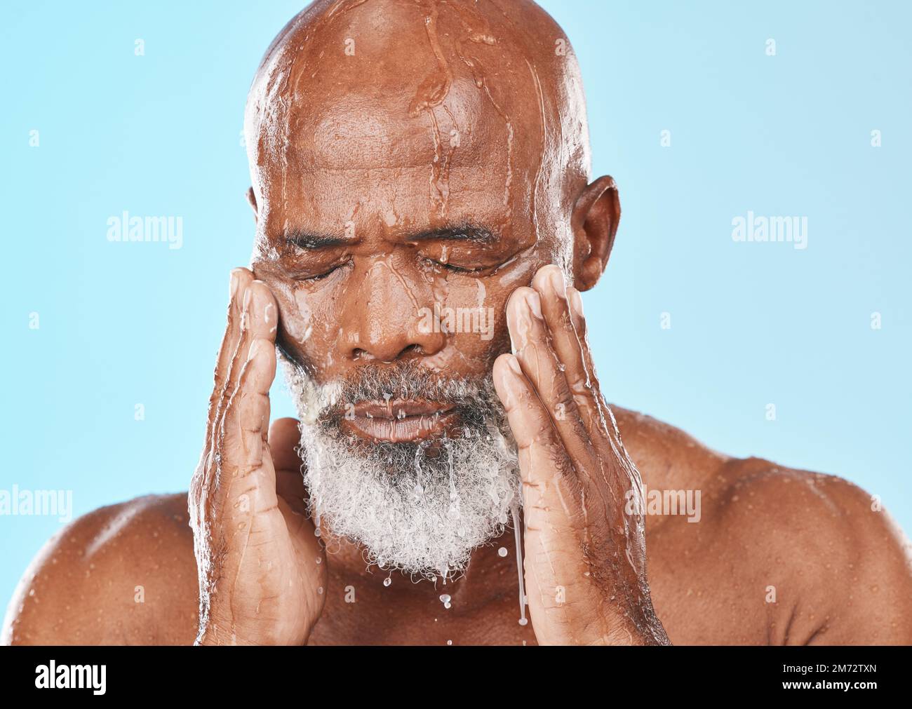 Black man, face and water drip in studio for cleaning cosmetics ...