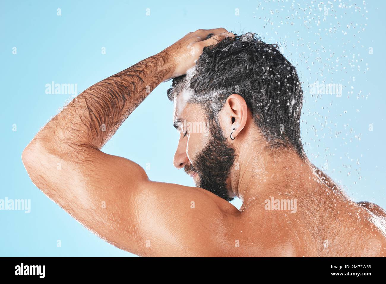 Face, shampoo shower and water splash of man in studio isolated on a ...