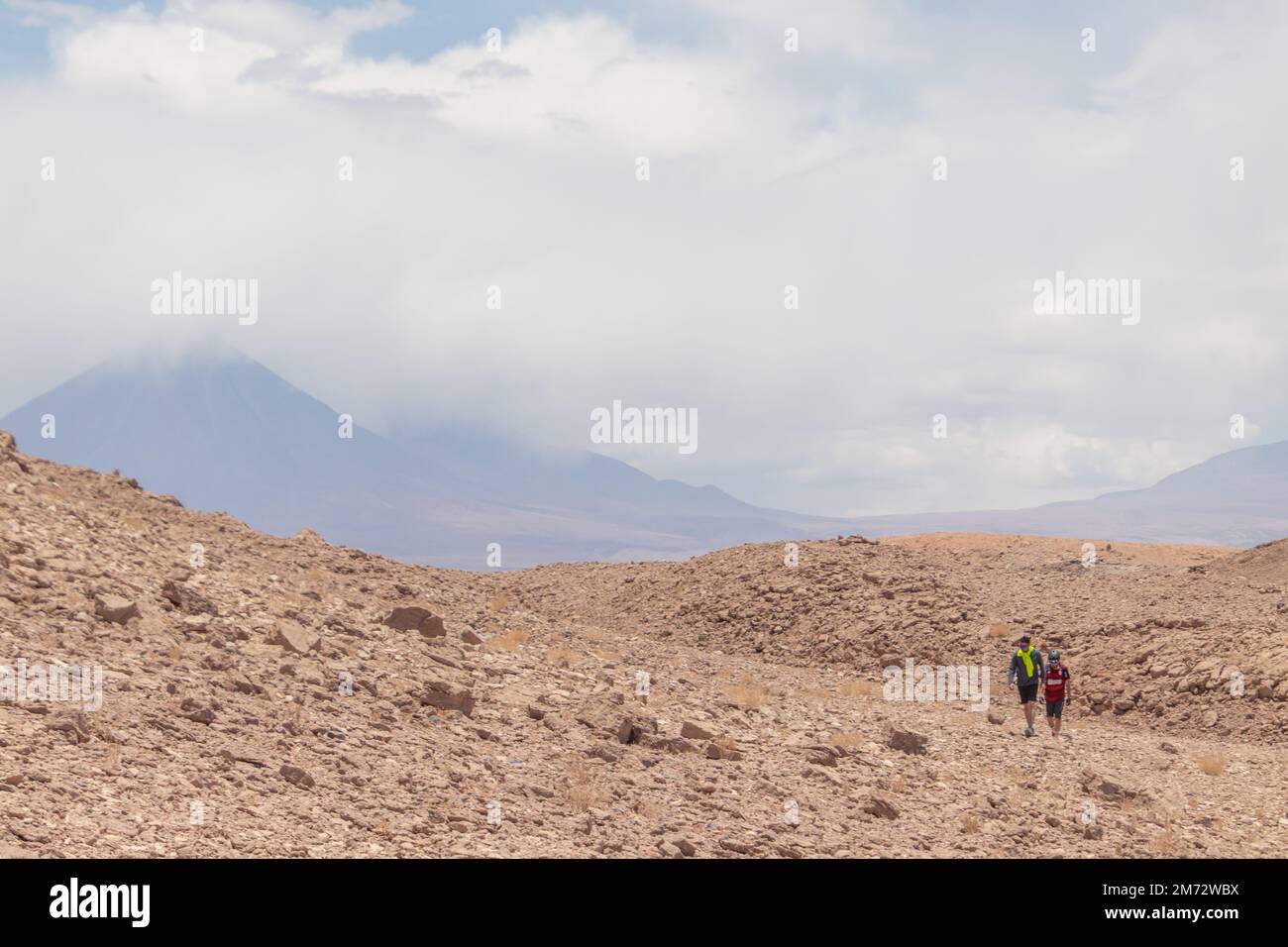 People hiking a mountain in the dryest part of Atacama, the most arid ...