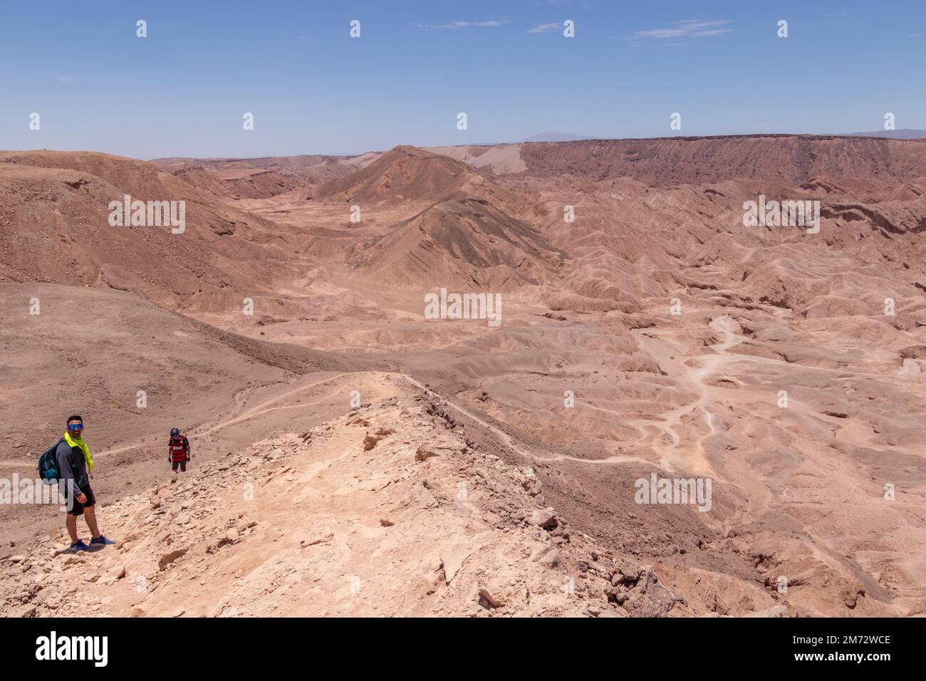 People hiking a mountain in the dryest part of Atacama, the most arid ...