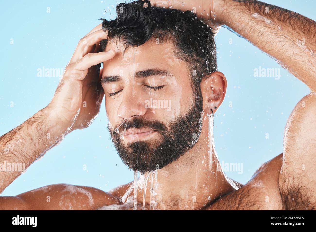 Face, hair care shower and water splash of man in studio isolated on a ...