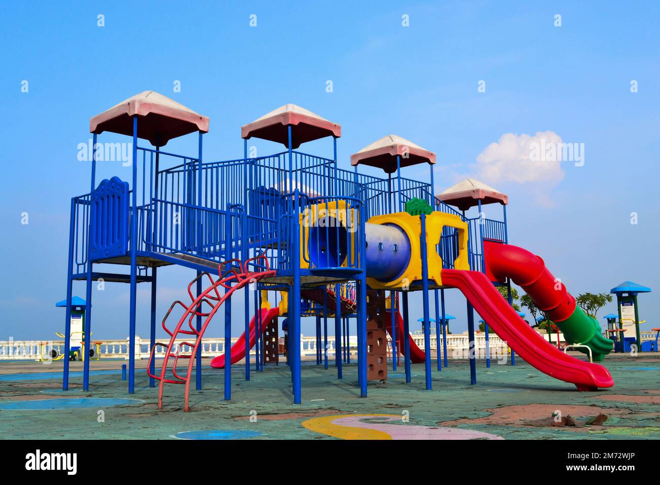 Colorful playground on blue sky background Stock Photo - Alamy