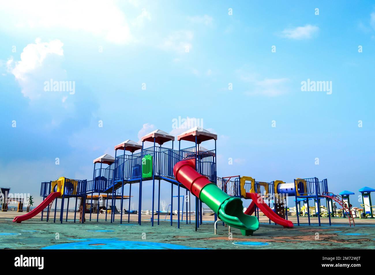 Colorful playground on blue sky background Stock Photo - Alamy