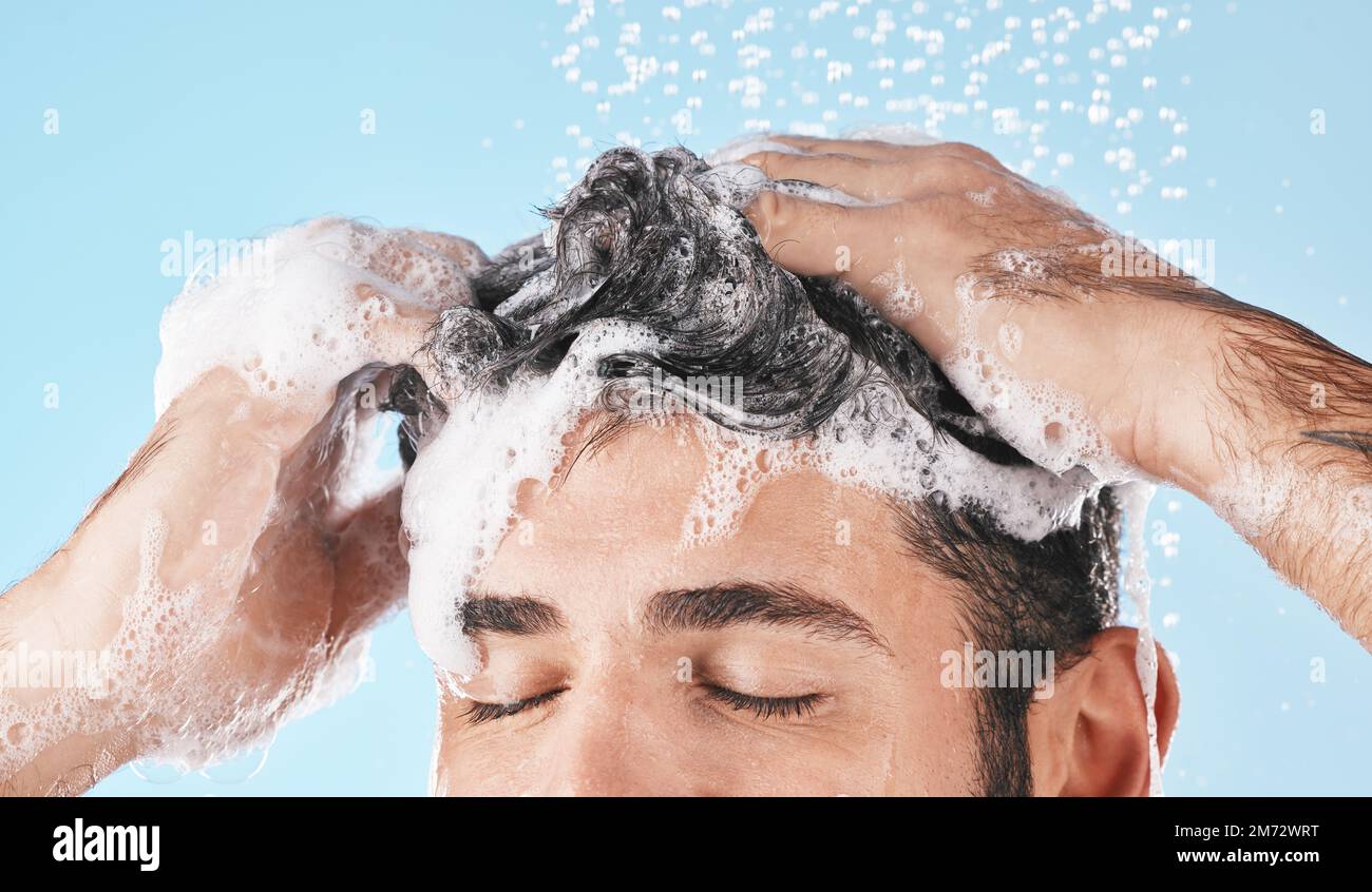 Face, water splash and shampoo shower of man in studio isolated on a ...
