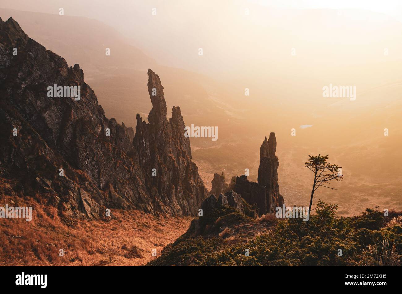 Artistic mountain scene. Sharp rock needles in the fog. Scenic mountain ...