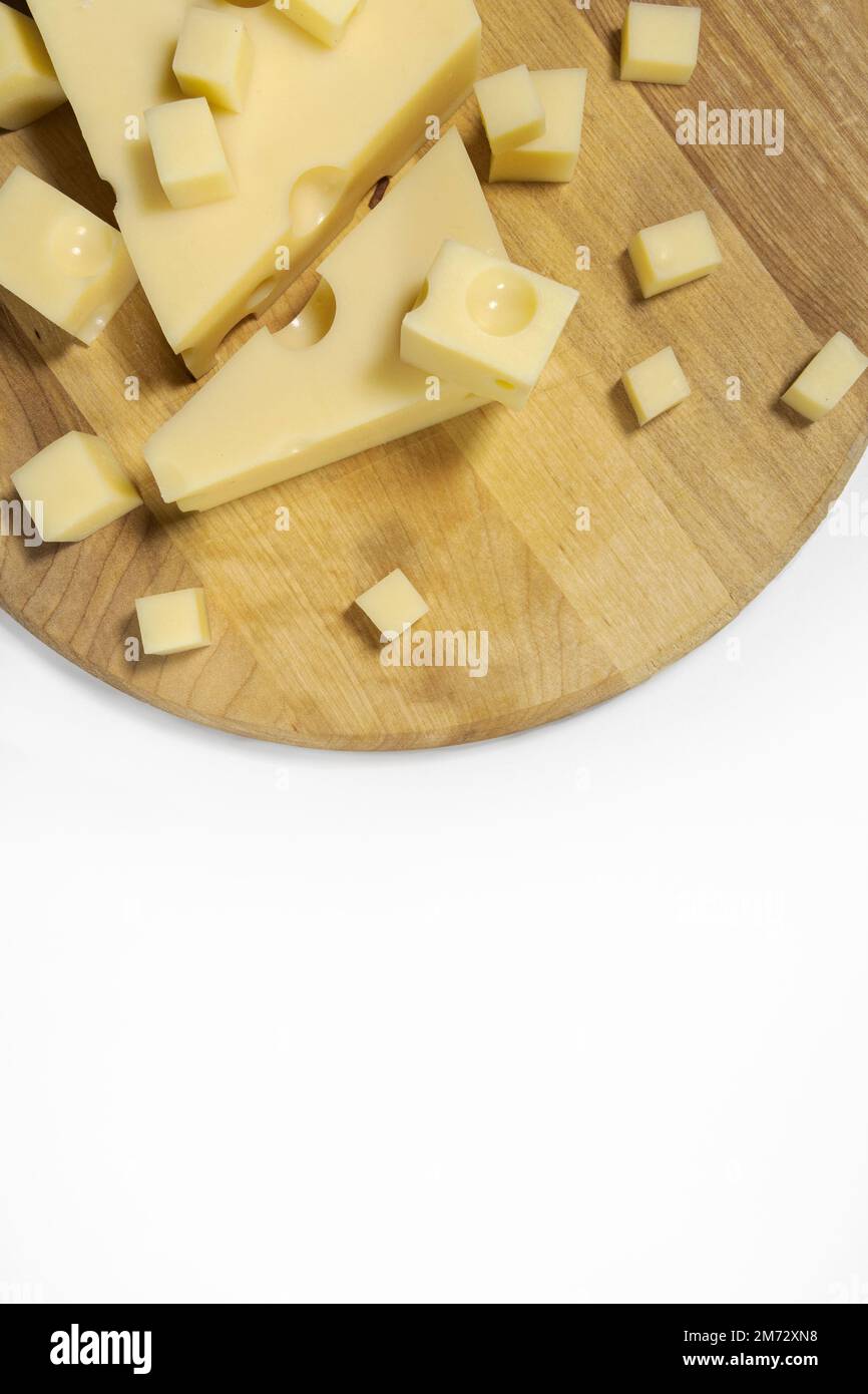Sliced emmental cheese on a cutting board. Vertically, from above on a ...
