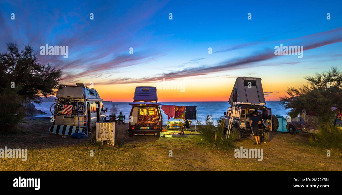 Campers and Motorhomes overlooking sunset in the Mediterranean sea from ...