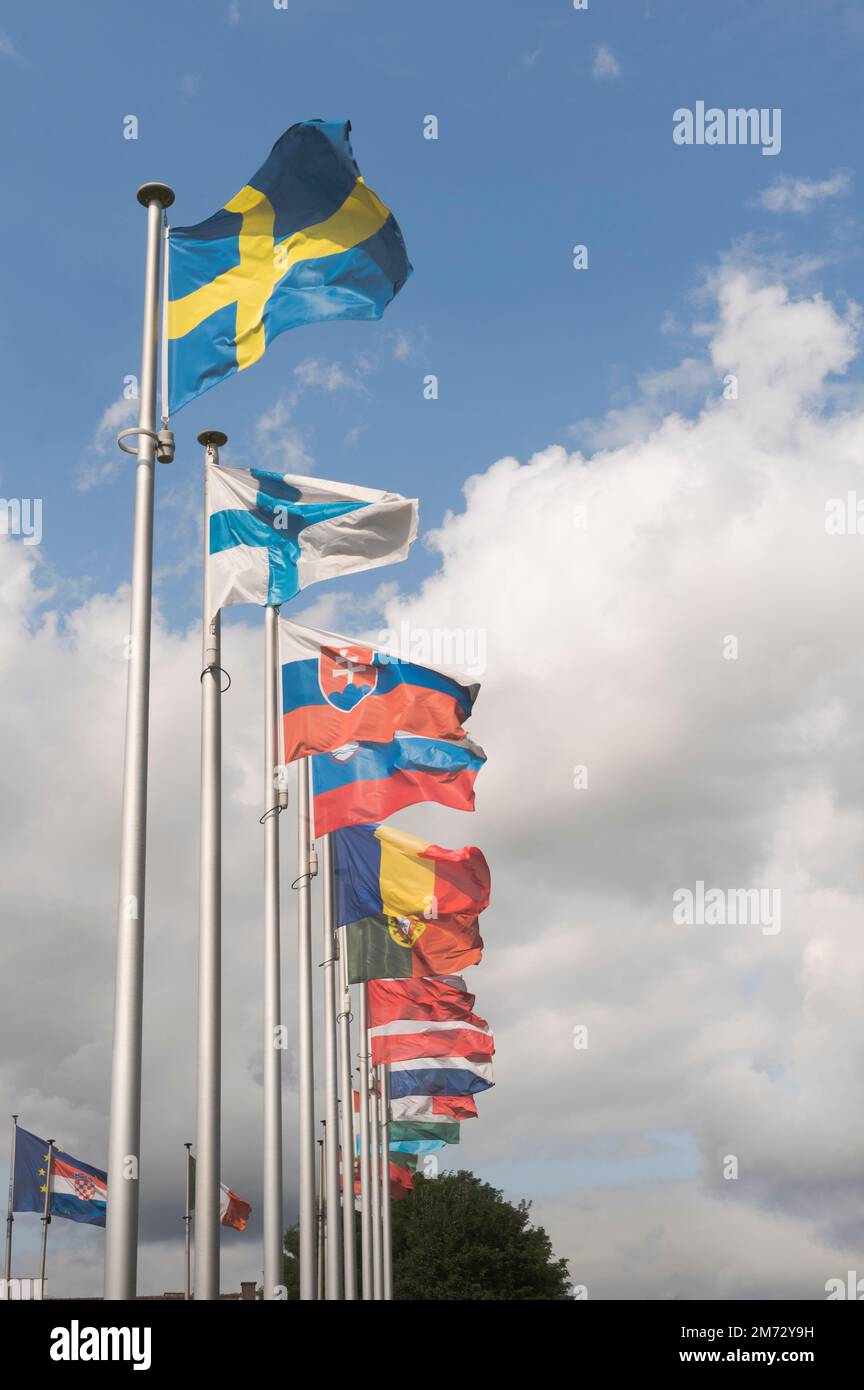A number of flags of the European Union on a background of blue sky and ...