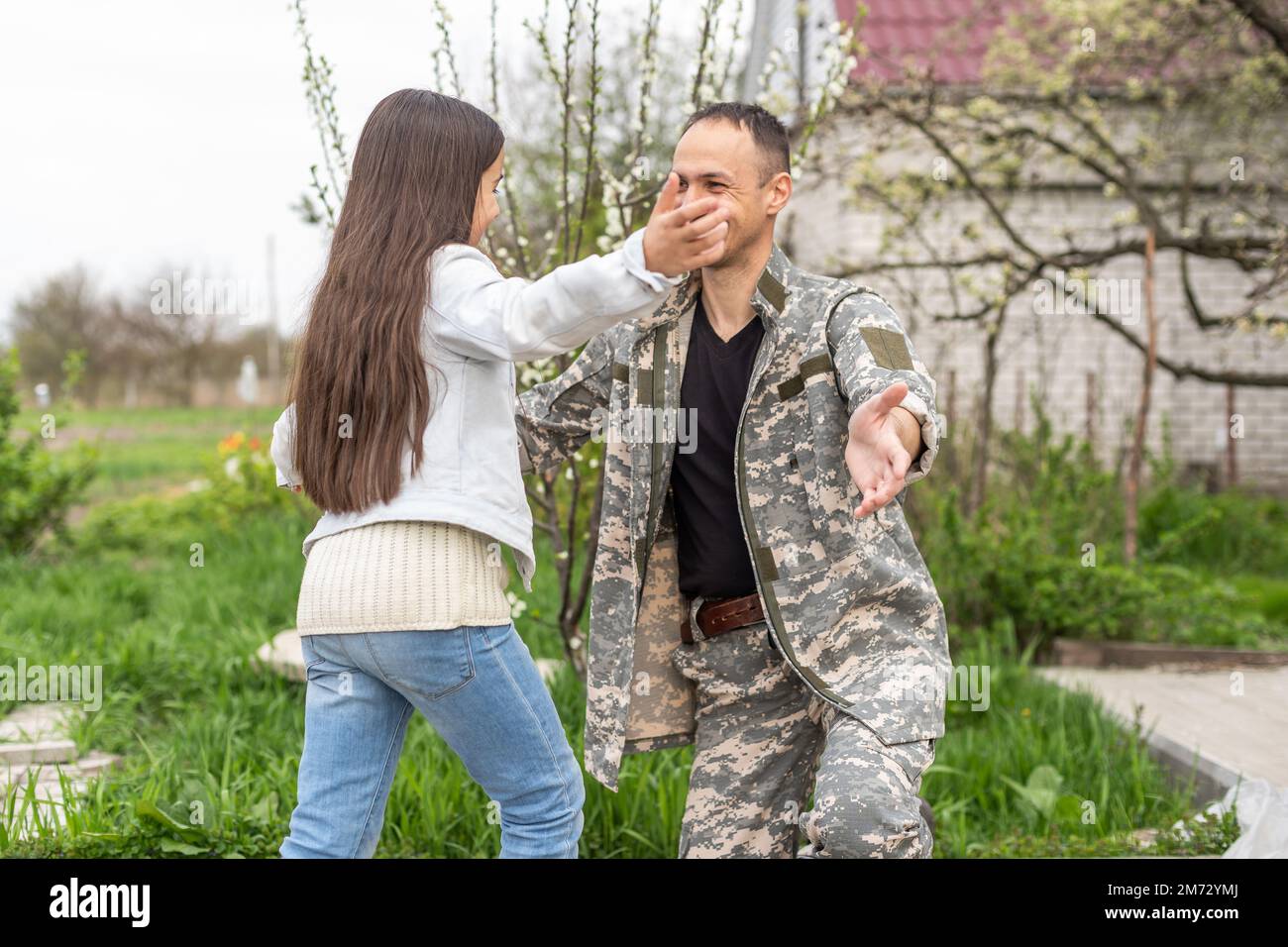 military reunion between father and daughter. military dad embracing ...