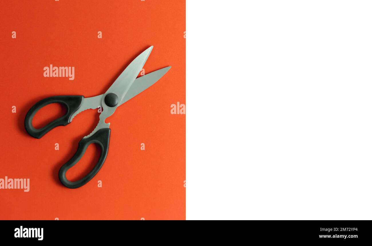 Open scissors on red white paper background Stock Photo - Alamy