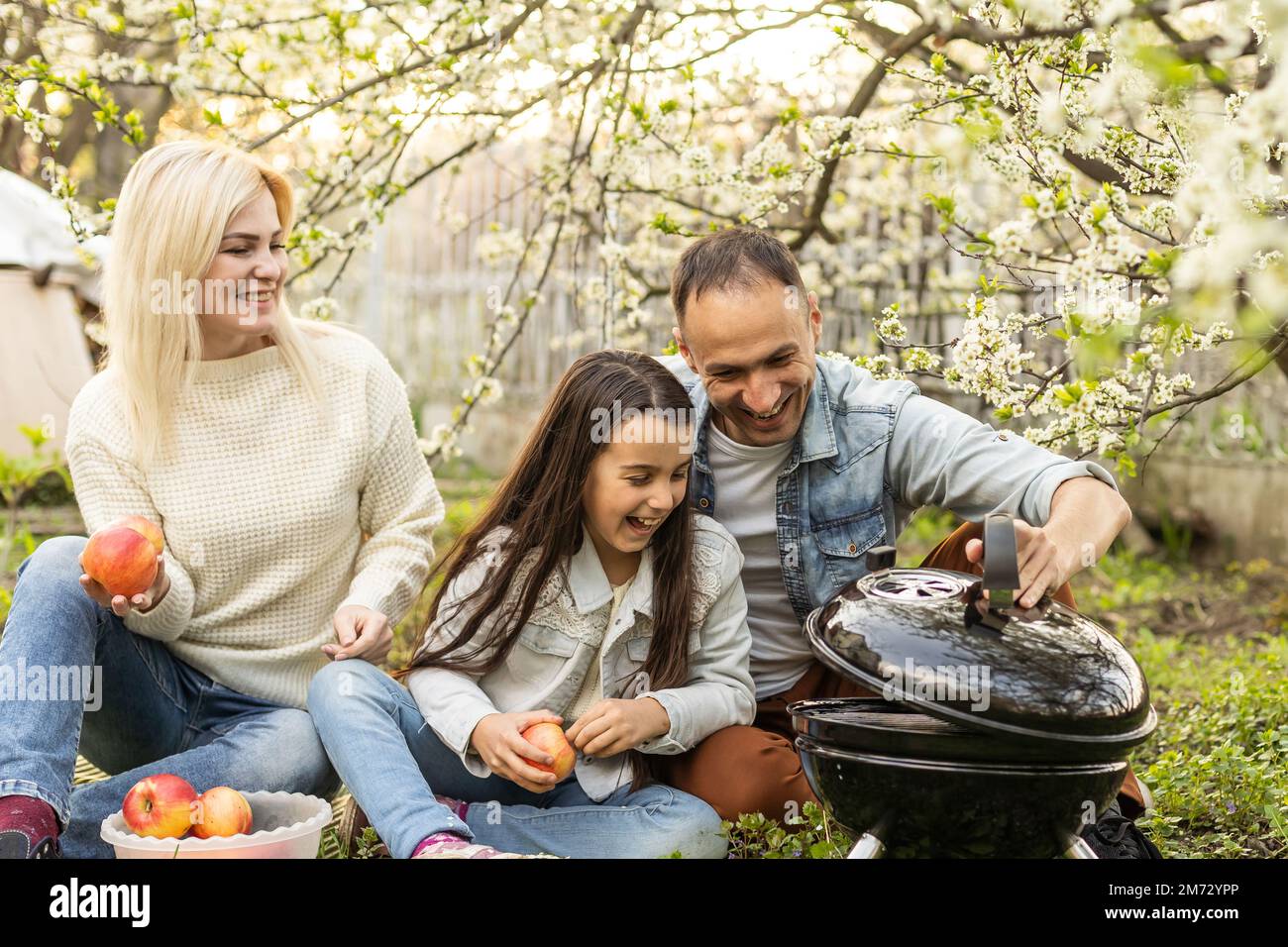 Happy family having barbecue with modern grill outdoors Stock Photo - Alamy