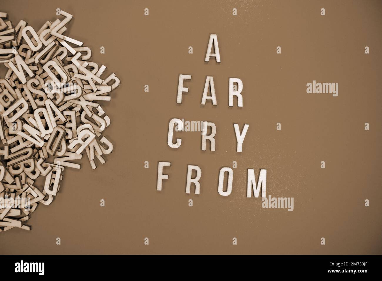 A FAR CRY FROM in wooden English language capital letters spilling from ...