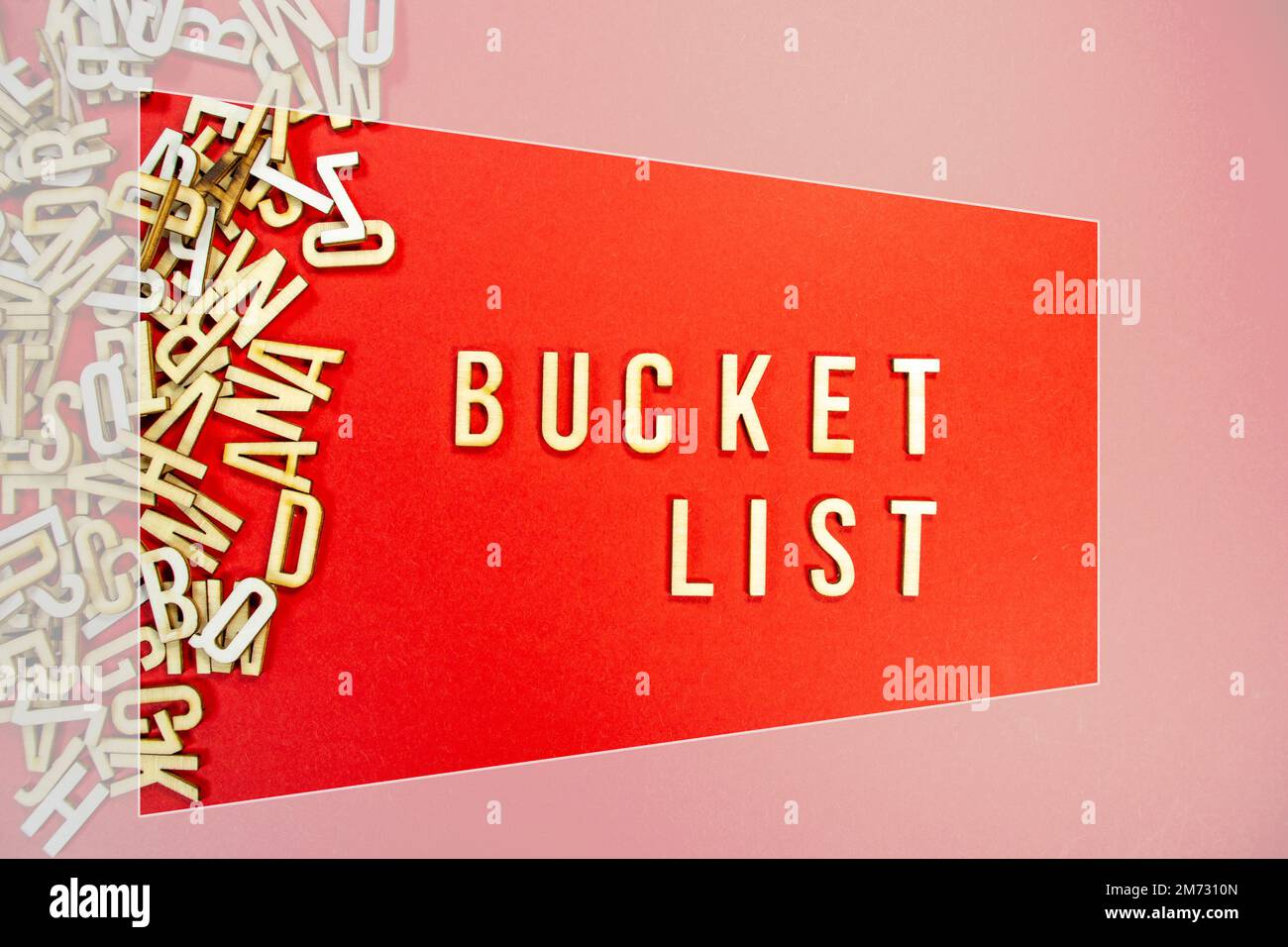 BUCKET LIST in wooden English language capital letters spilling from a ...