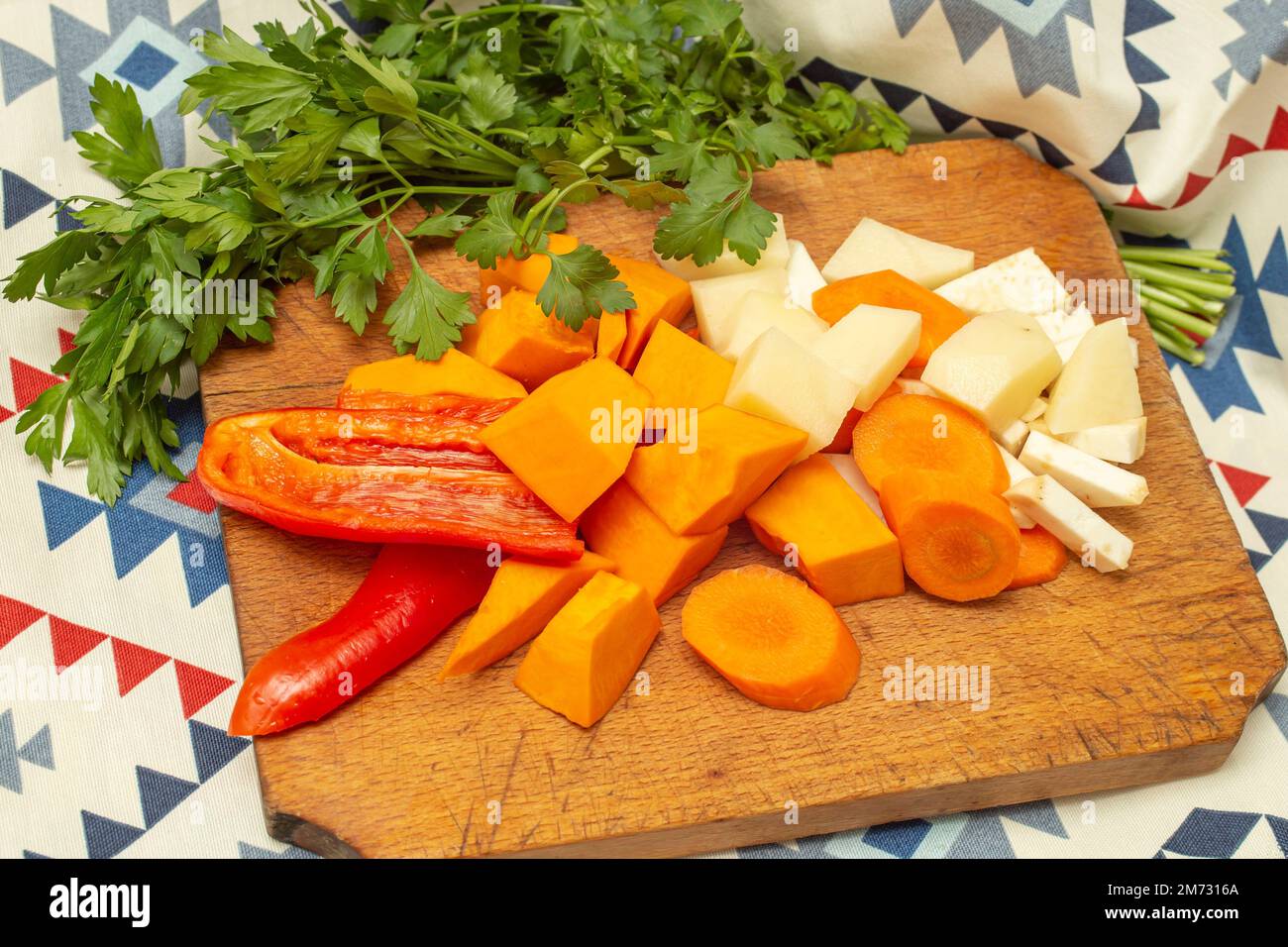 Various vegetables chopped on a wood board ready for soup, soft focus ...
