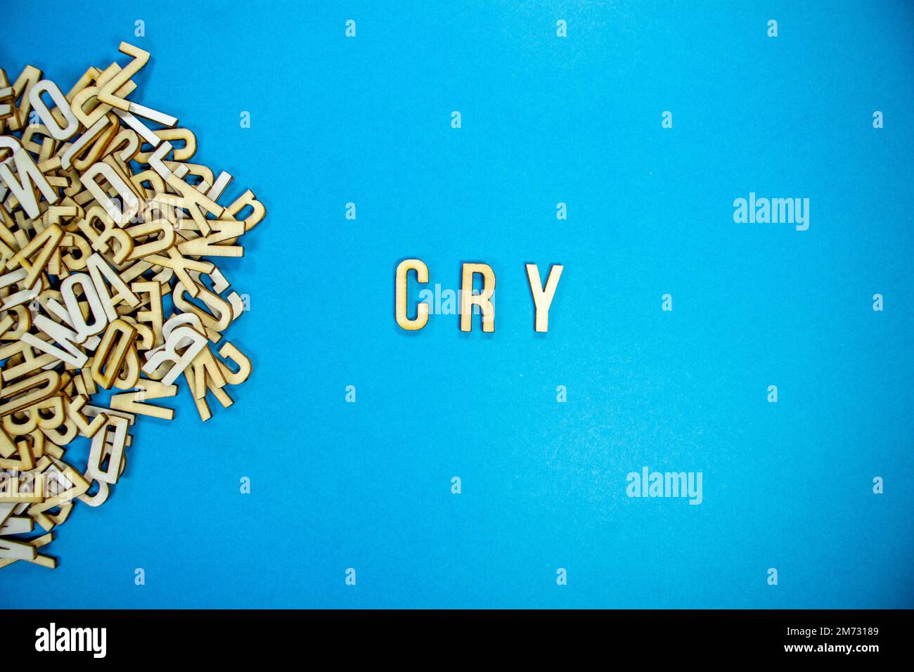 CRY in wooden English words language capital letters spilling from a ...