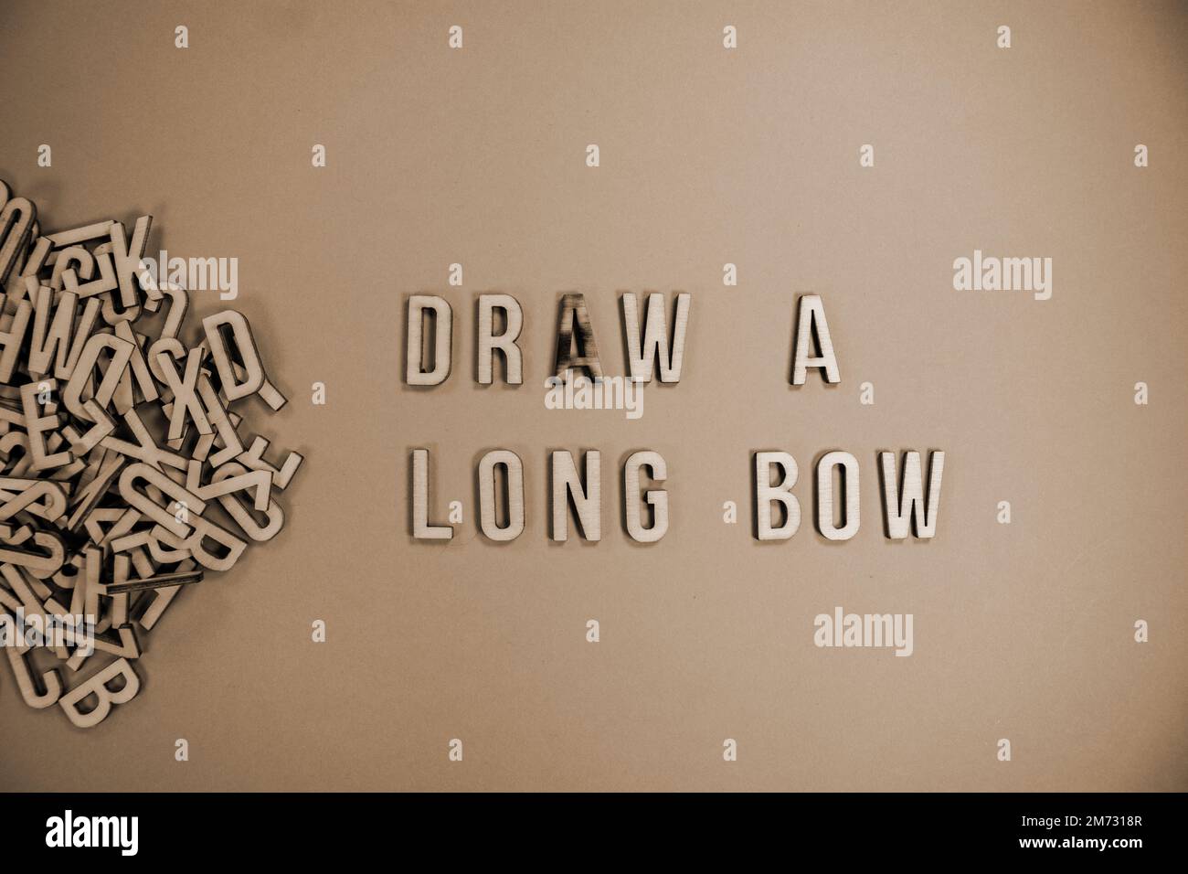 DRAW A LONG BOW in wooden English language capital letters spilling ...