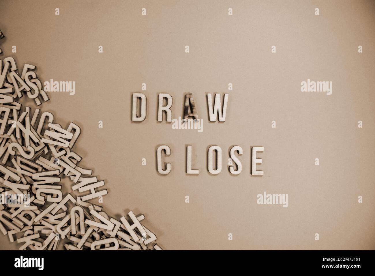 DRAW A LONG BOW in wooden English language capital letters spilling ...