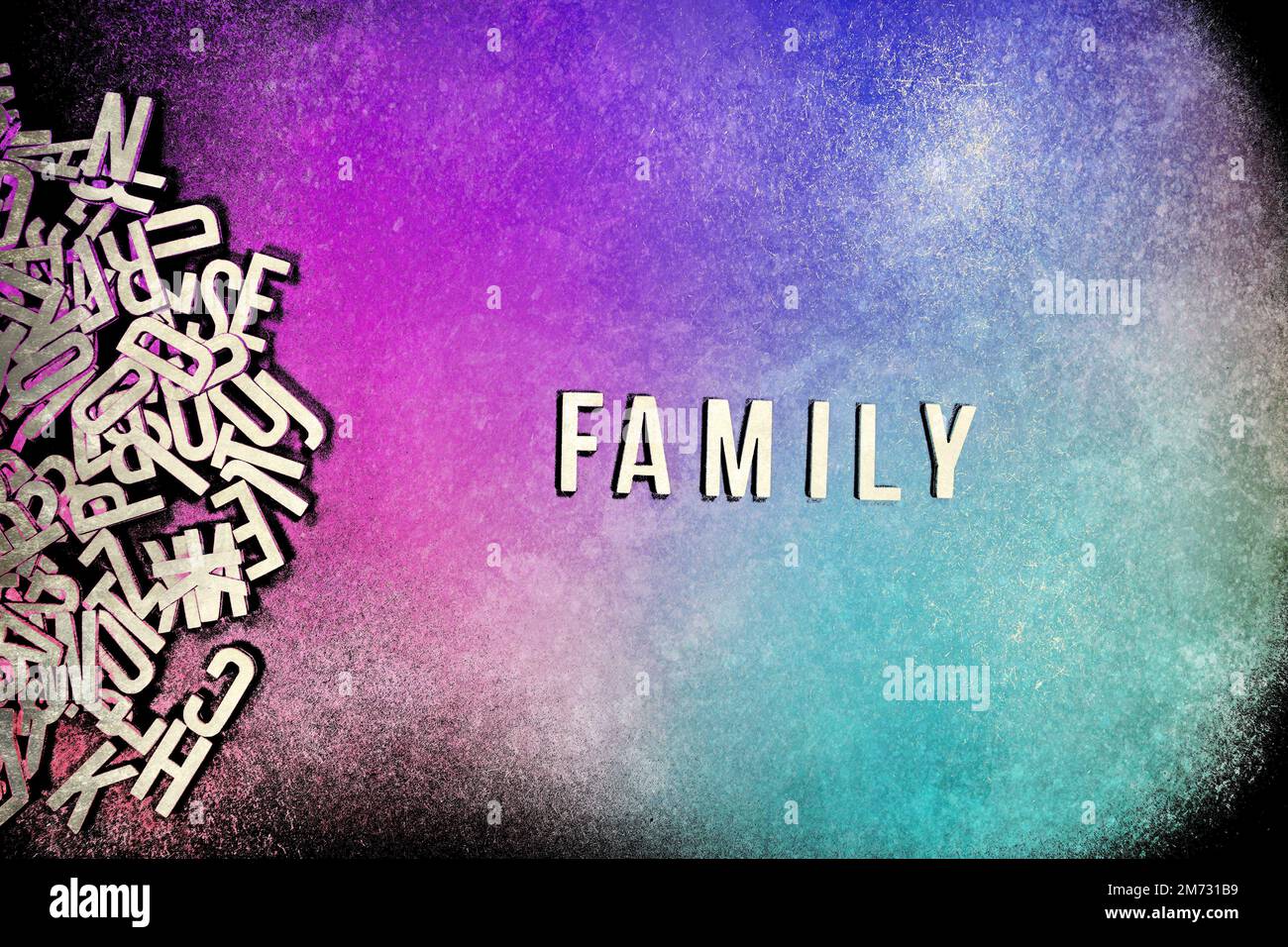 FAMILY in wooden English language capital letters spilling from a pile ...