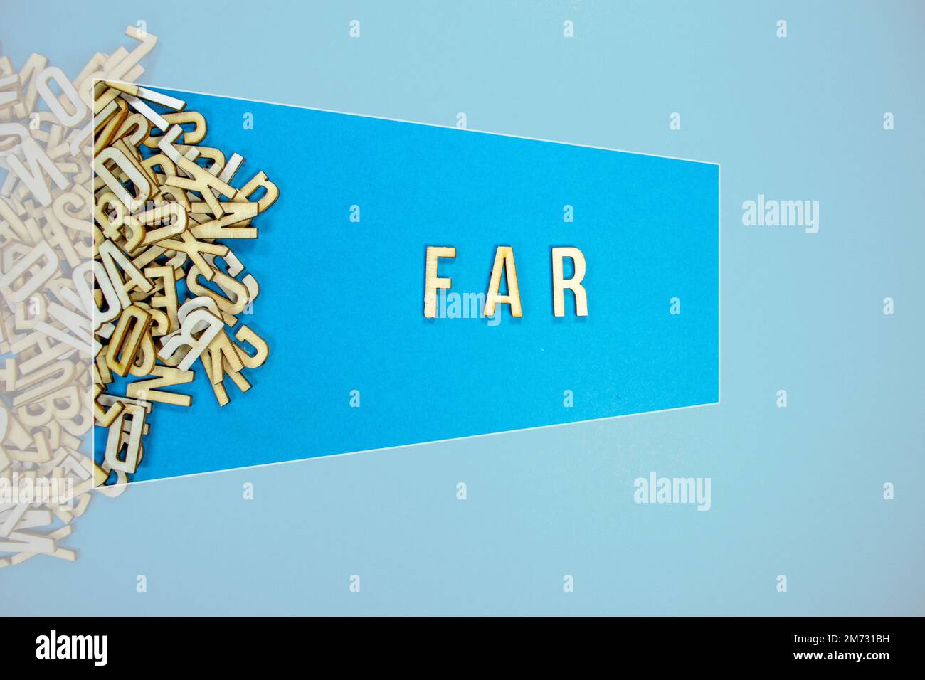 FAR in wooden English words language capital letters spilling from a ...