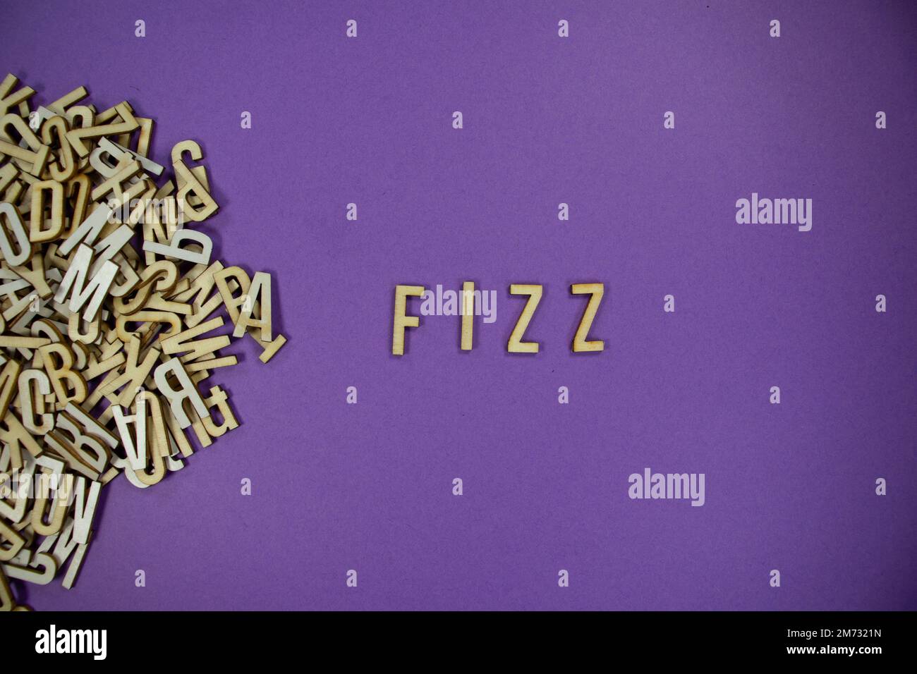 pile of wooden English language capital letters spilling into words ...