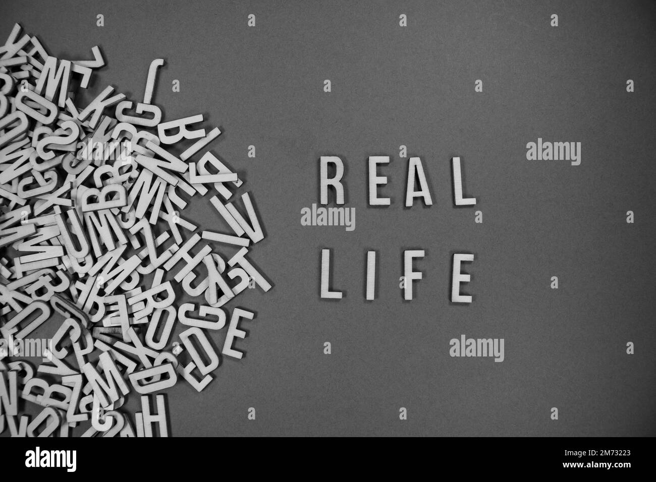 pile of wooden English language capital letters spilling into words ...