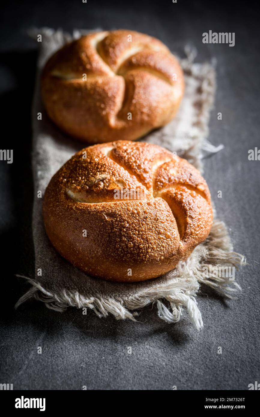Closeup of golden rolls on linen napkin on concrete Stock Photo - Alamy
