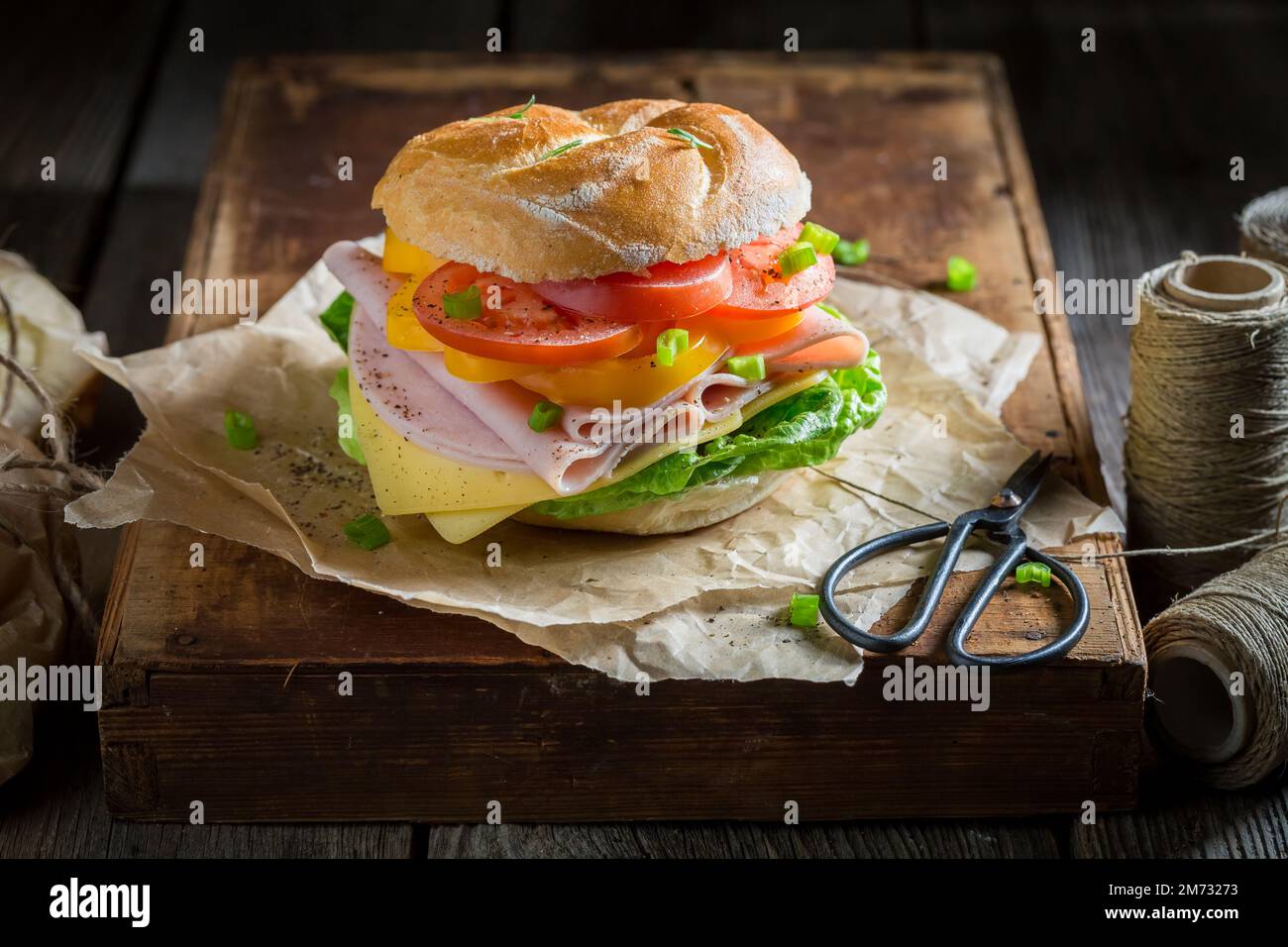 Delicious and crispy take away sandwich with ham, tomatoes and cheese ...