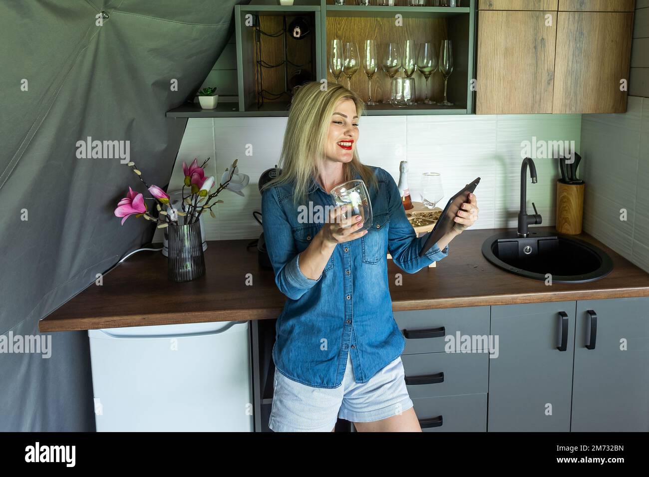 a woman with a tablet has a video chat Stock Photo - Alamy