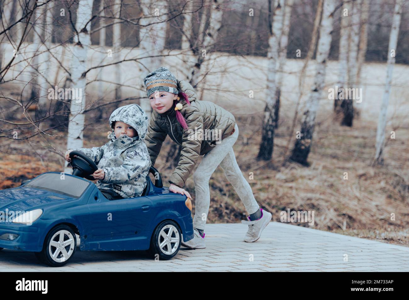 Two happy kids having fun drive a blue toy car, road trip adventure ...