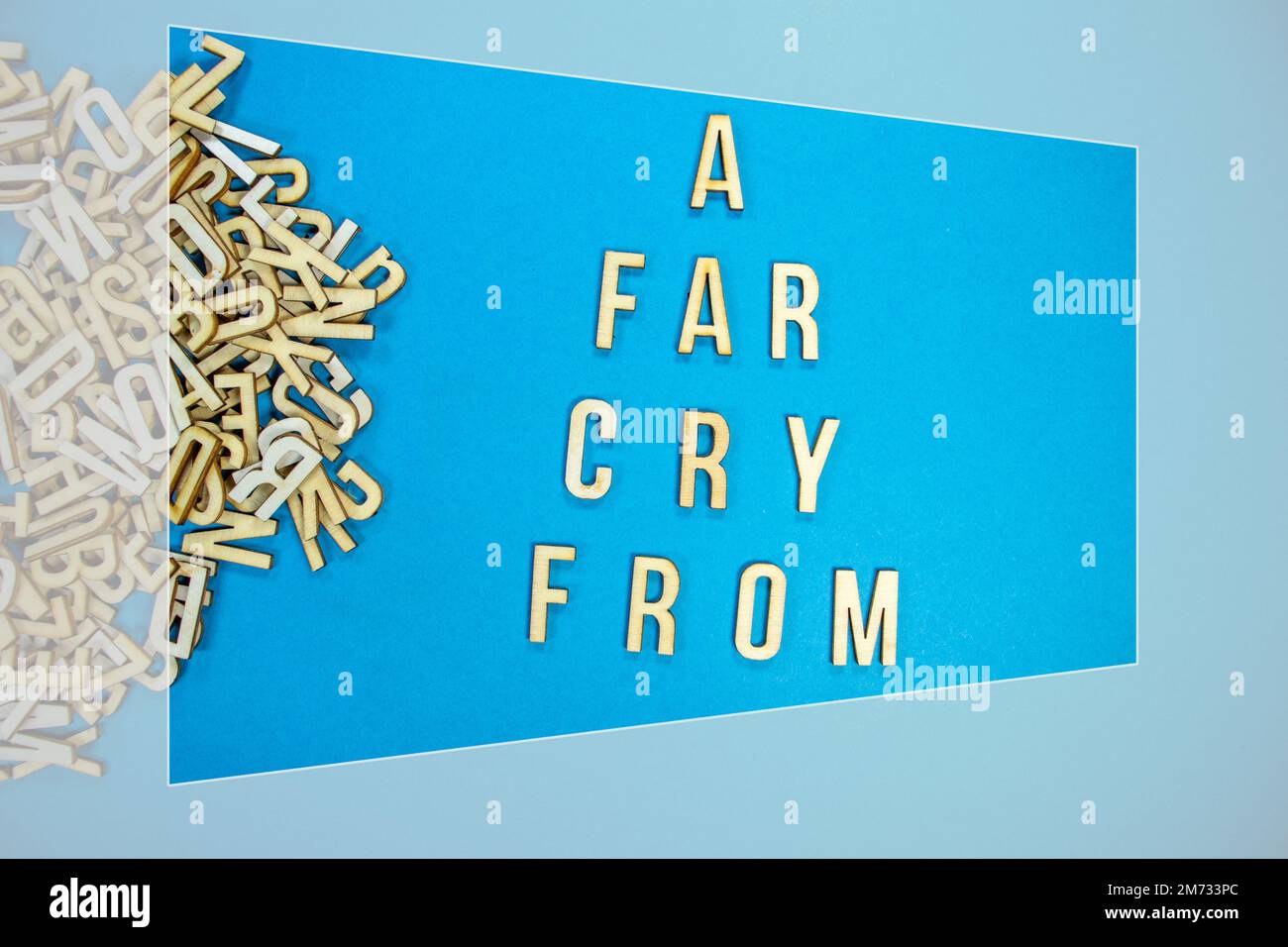 A FAR CRY FROM in wooden English language capital letters spilling from ...