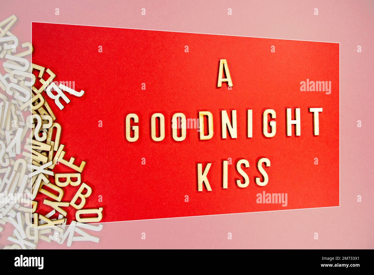 A GOODNIGHT KISS in wooden English language capital letters spilling ...
