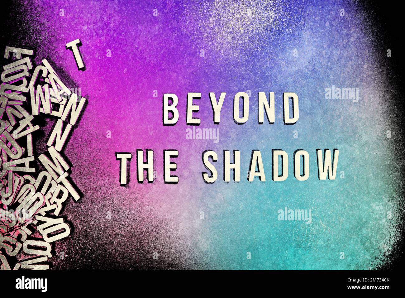 BEYOND THE SHADOW in wooden English language capital letters spilling from a pile of letters ...