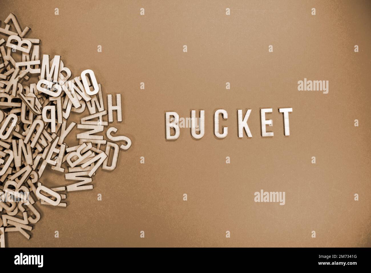 BUCKET in wooden English words language capital letters spilling from a ...