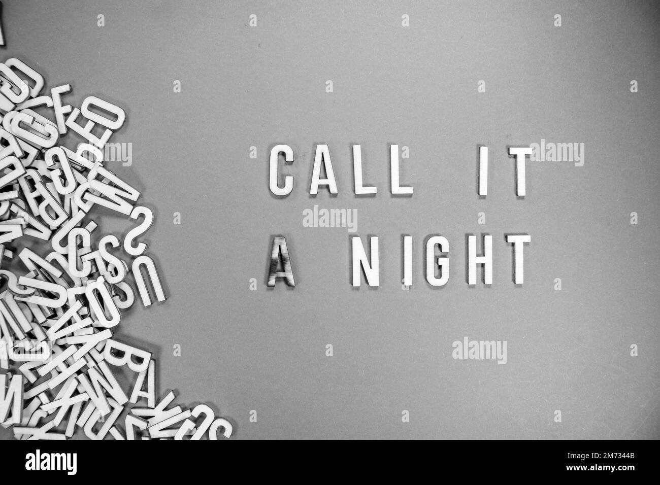 CALL IT A NIGHT in wooden English language capital letters spilling ...