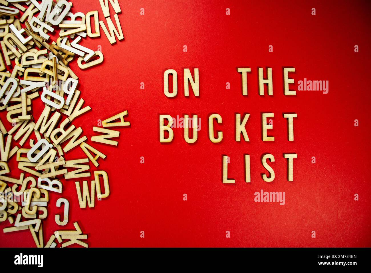 ON THE BUCKET LIST in wooden English language capital letters spilling ...