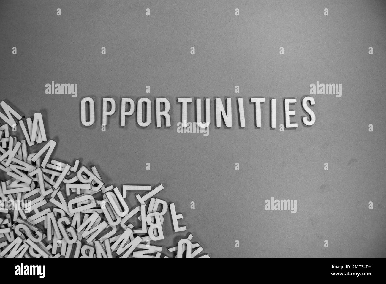 OPPORTUNITIES in wooden English words language capital letters spilling ...