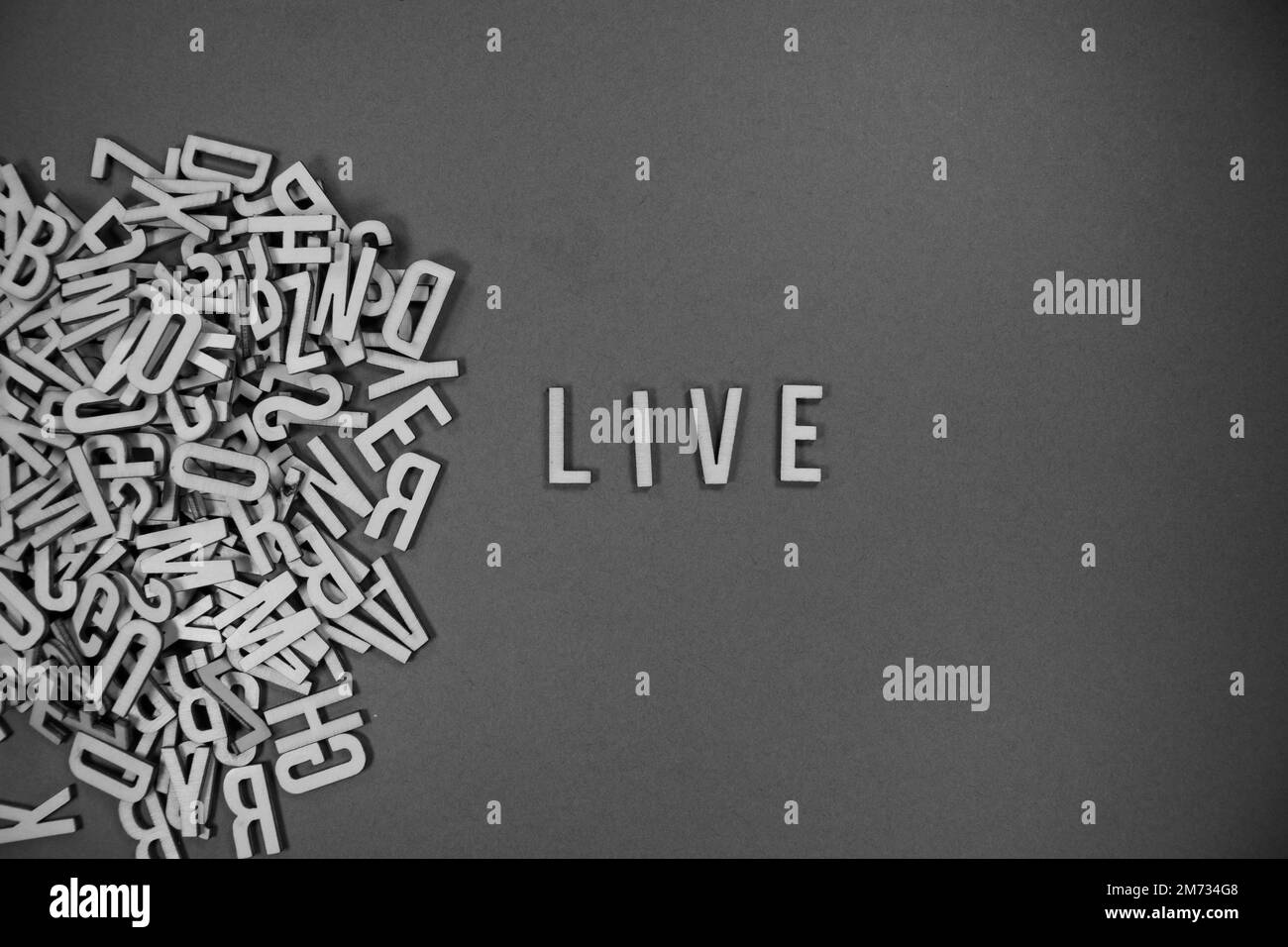 pile of wooden English language capital letters spilling into words ...