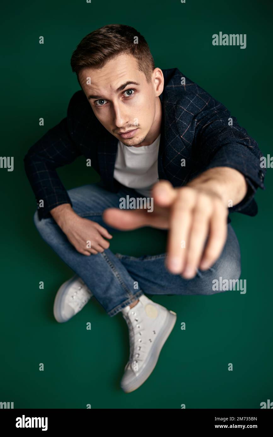 handsome man in plaid jacket sitting on the floor Stock Photo - Alamy