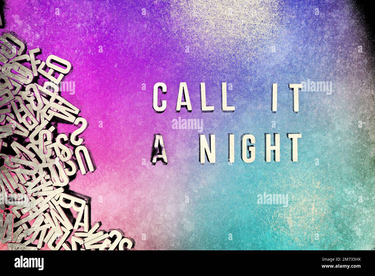 CALL IT A NIGHT in wooden English language capital letters spilling ...